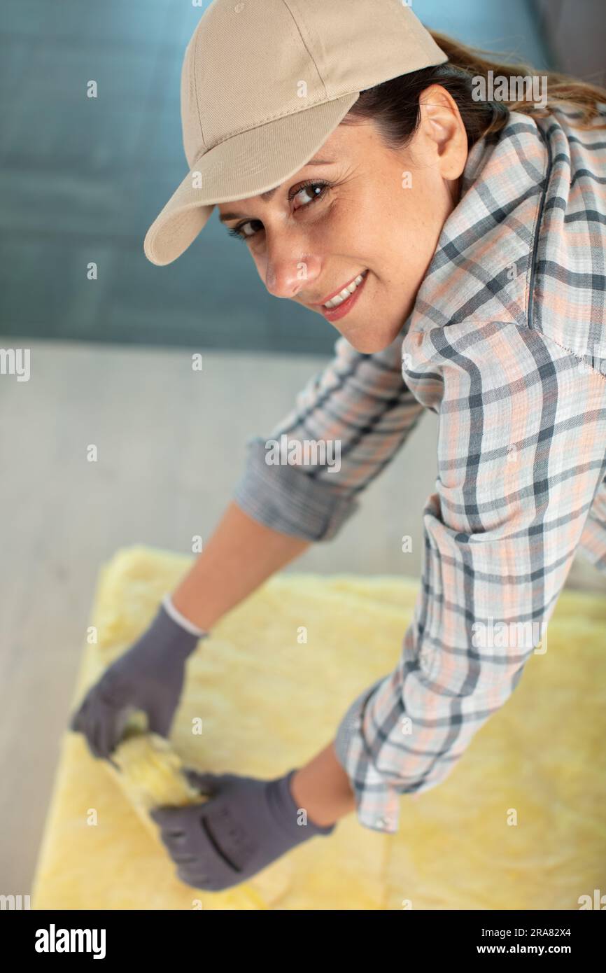 female builder is getting insulation sheets Stock Photo - Alamy