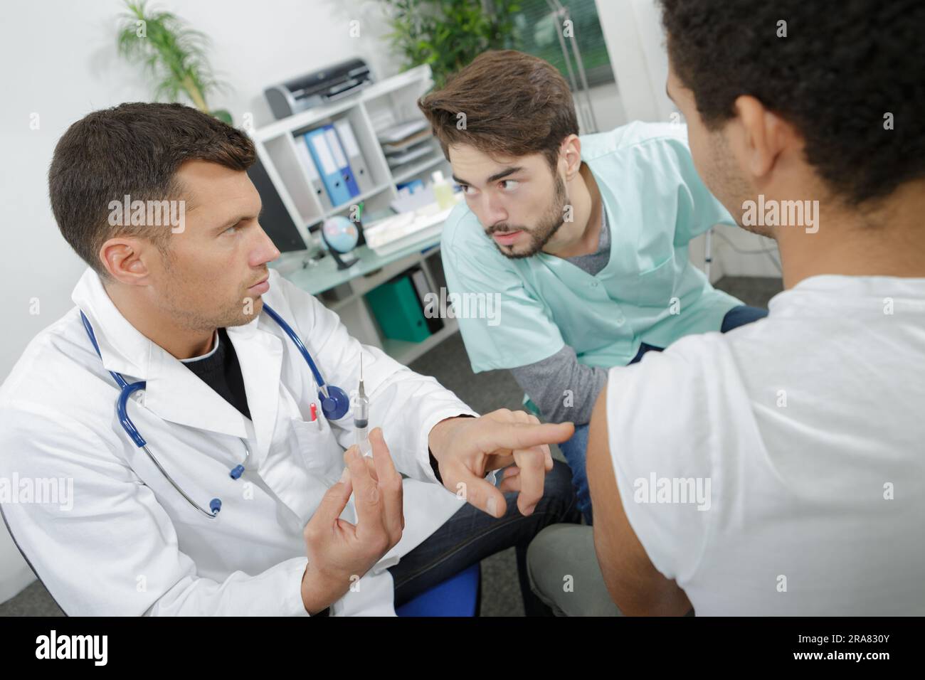 junior doctor learning how to inject patient Stock Photo - Alamy