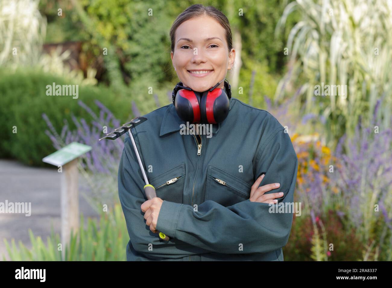 portrait of a woman with a rake Stock Photo - Alamy