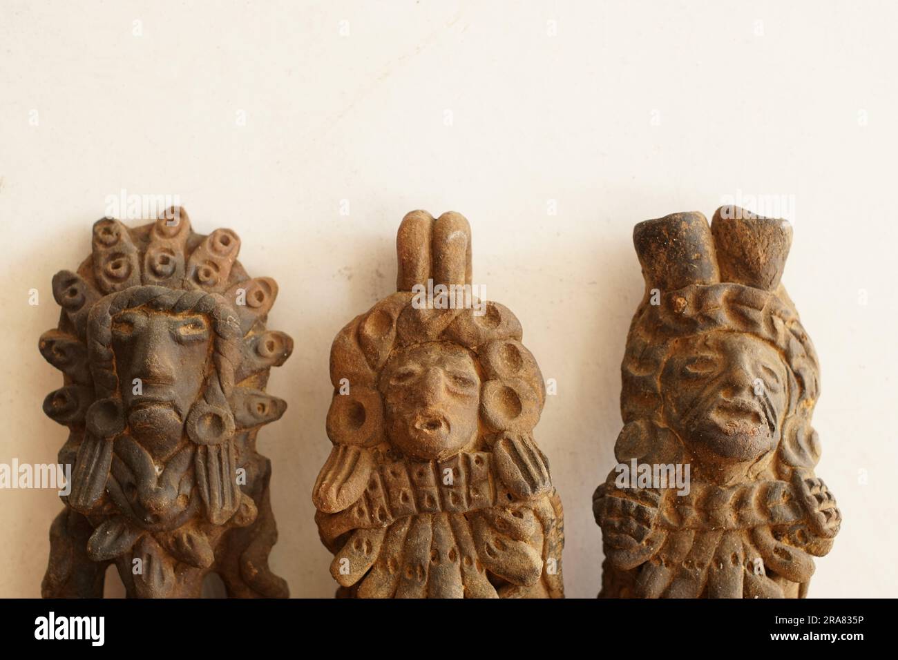 Mayan god clay statues on wooden and white background with copy text ...
