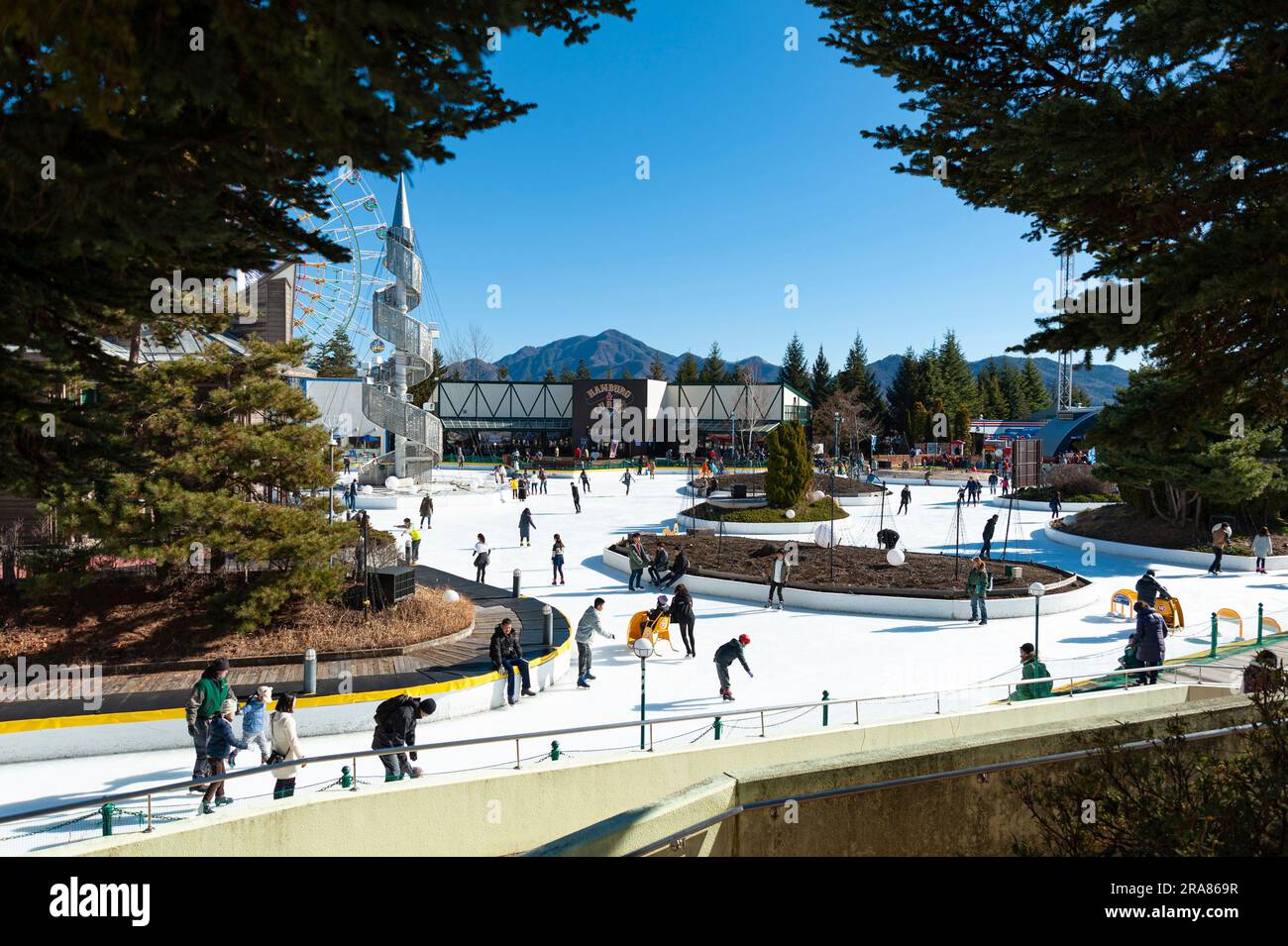 Ice skating area with ferris wheel. Background with beautiful blue sky ...