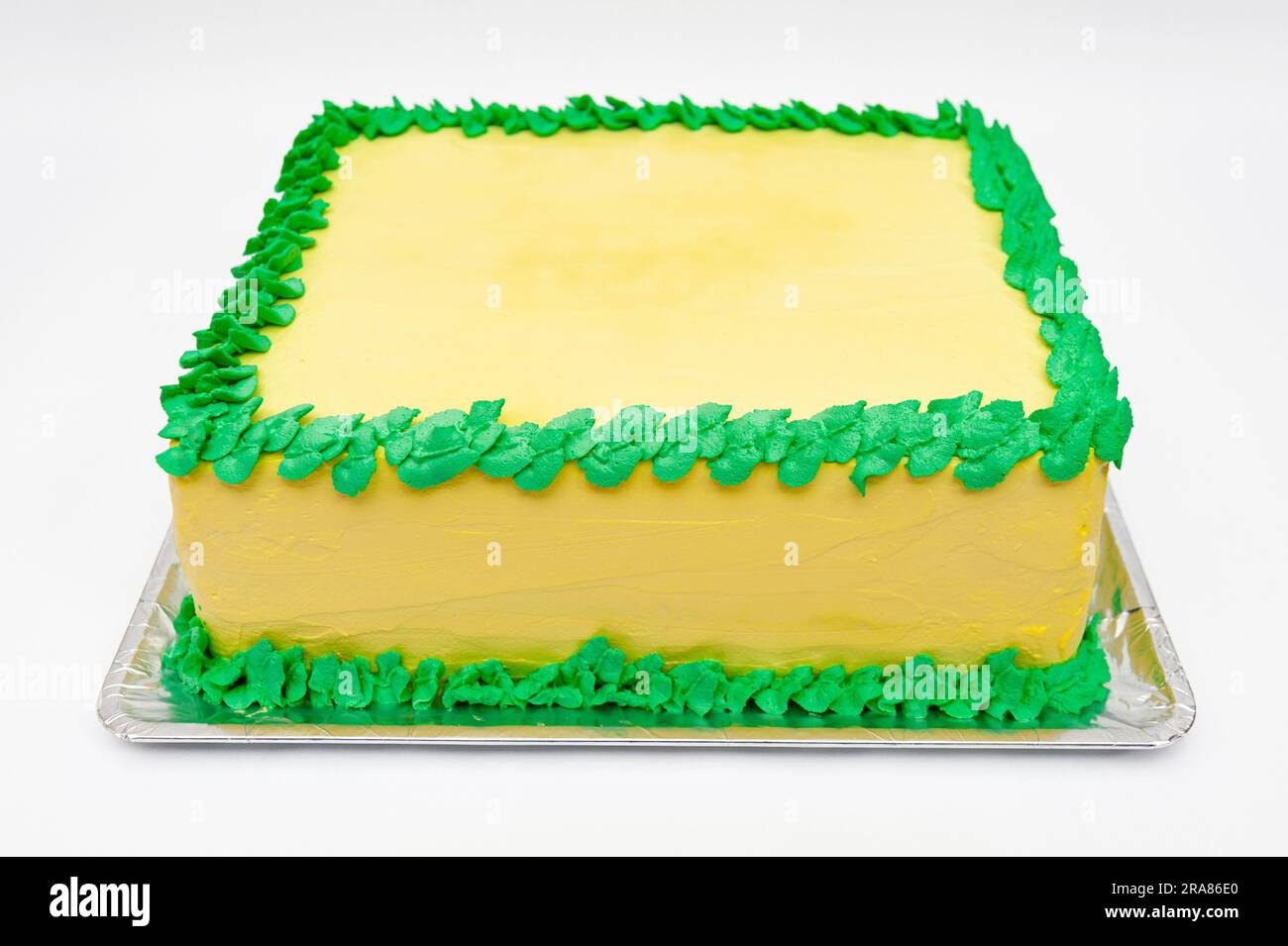 Birthday cake with green and yellow colors isolated on white background ...