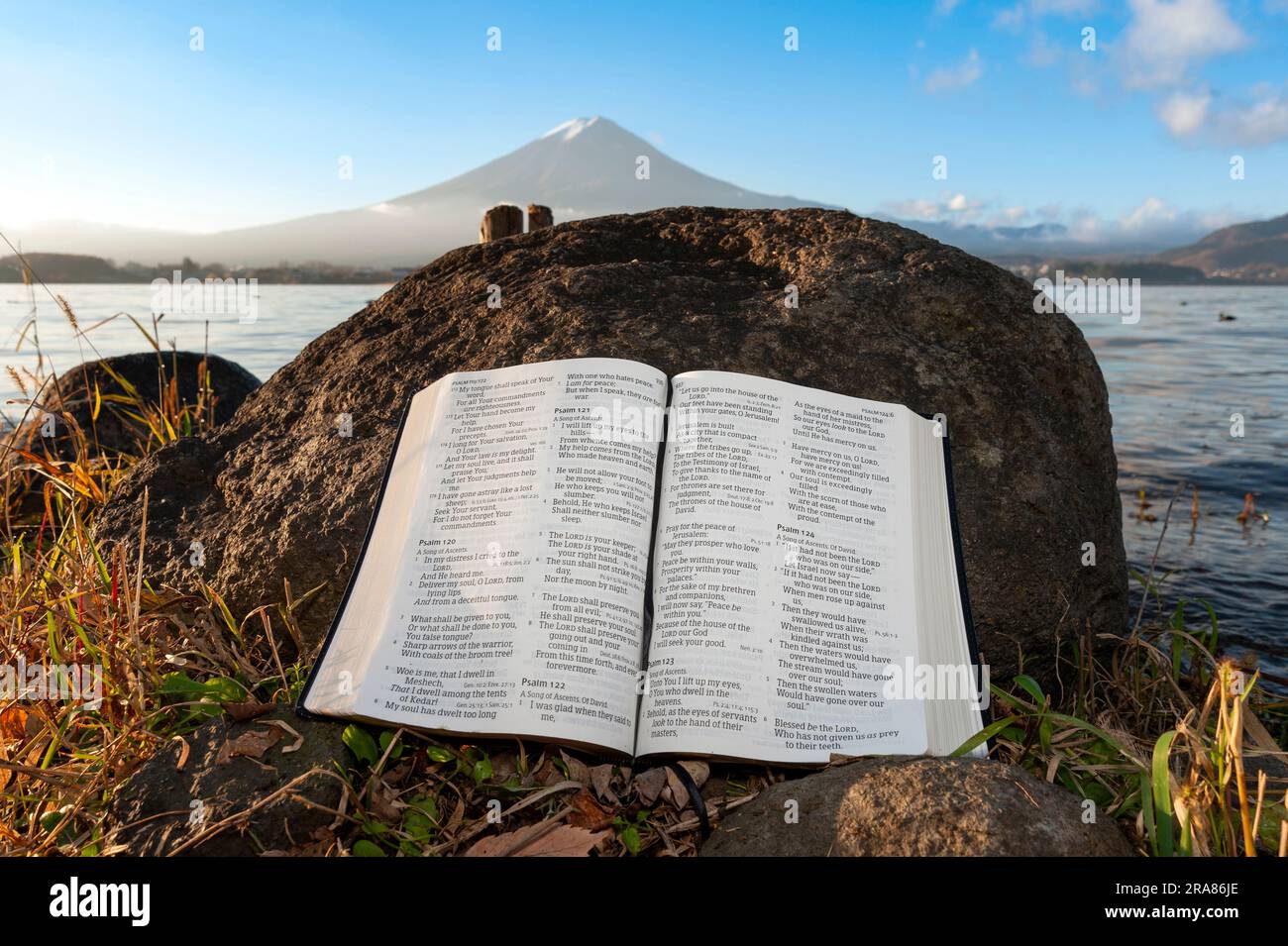 Holy Bible open to Psalms 121, 122, 123 and 124 leaning against a rock ...