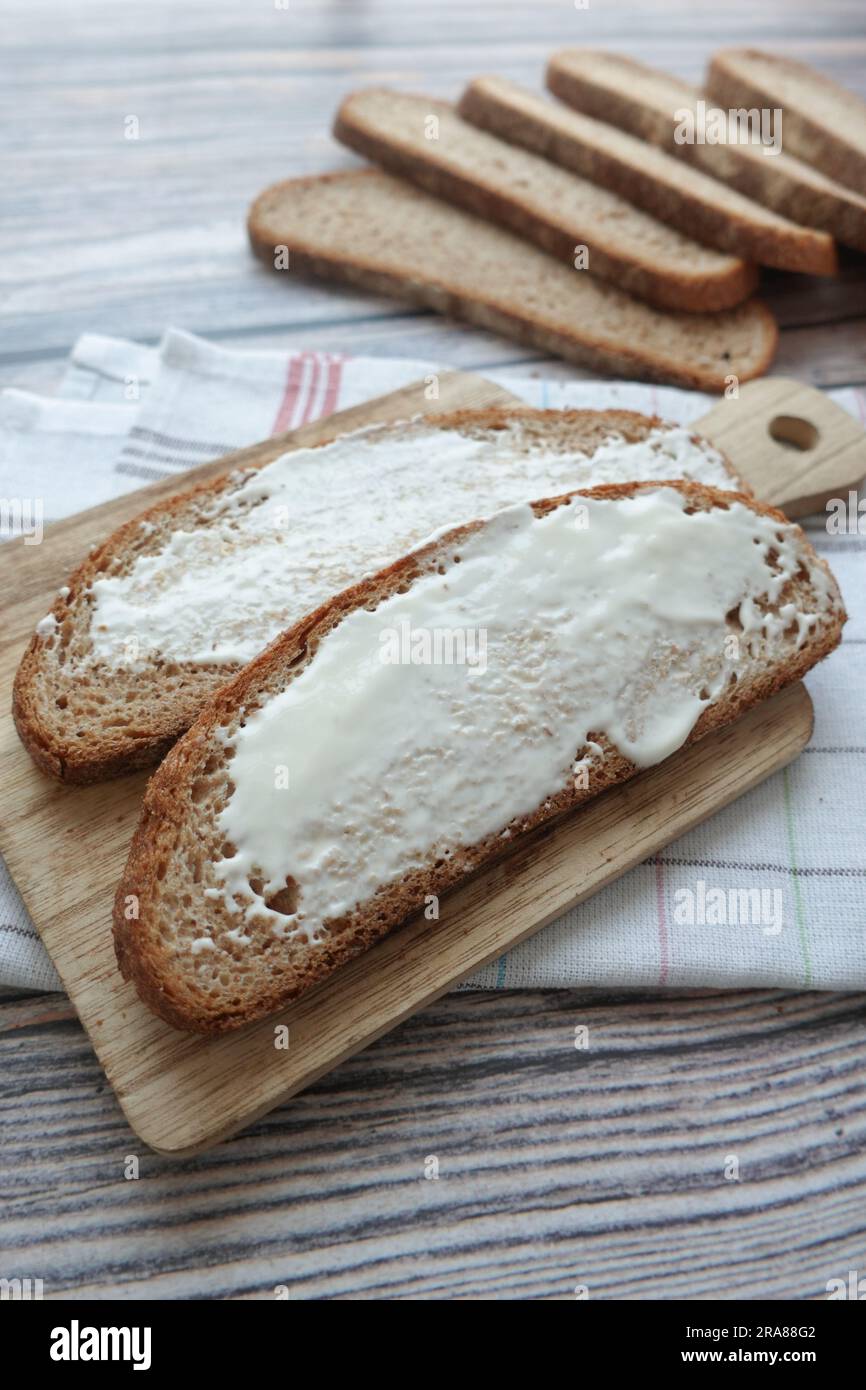 cream cheese spread on a Slice of bread Stock Photo - Alamy