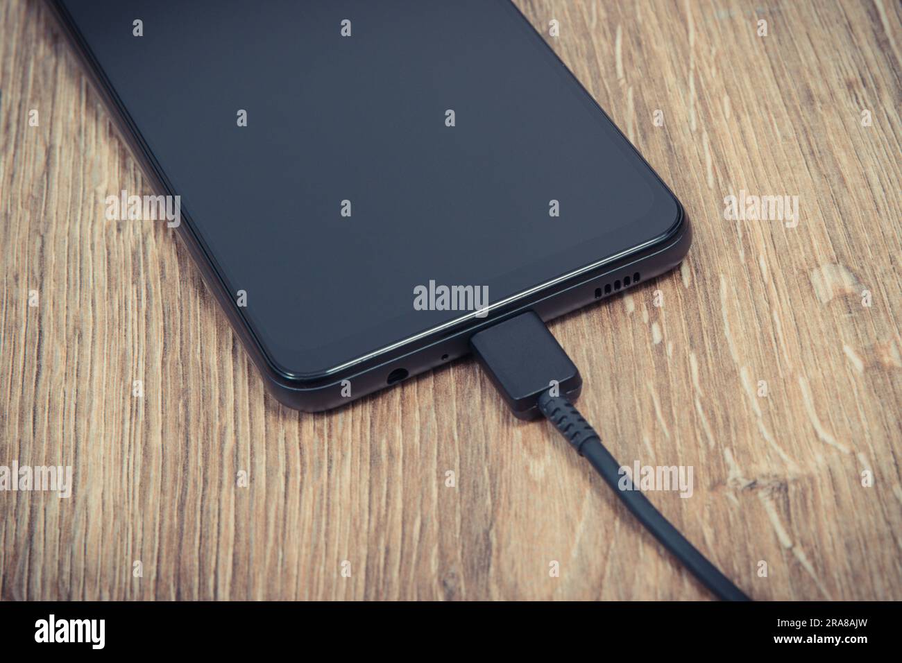 Smartphone, mobile phone and connected cable of charger. Mobile phone ...
