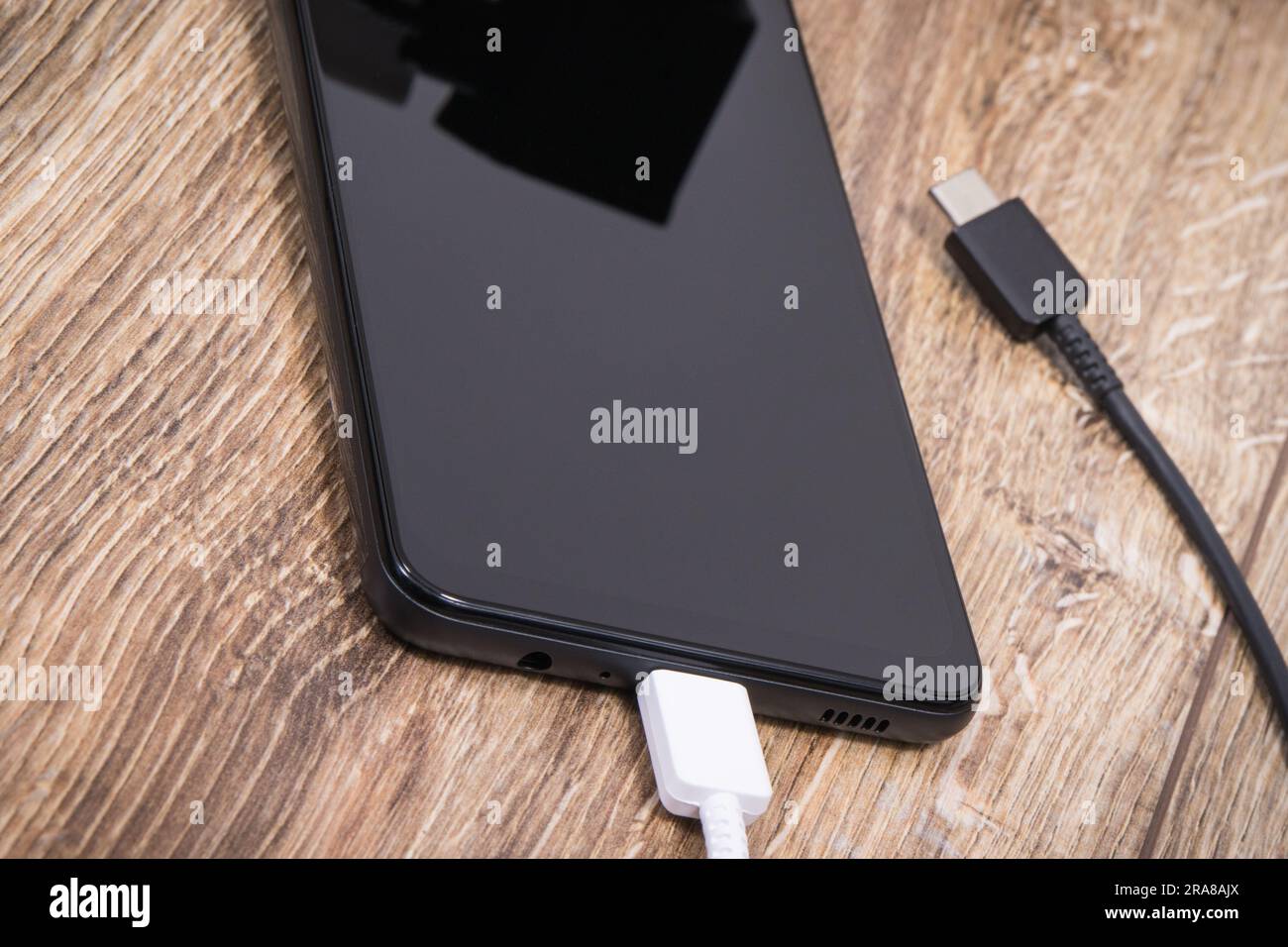 Smartphone with charger cables. Mobile phone charging concept Stock ...