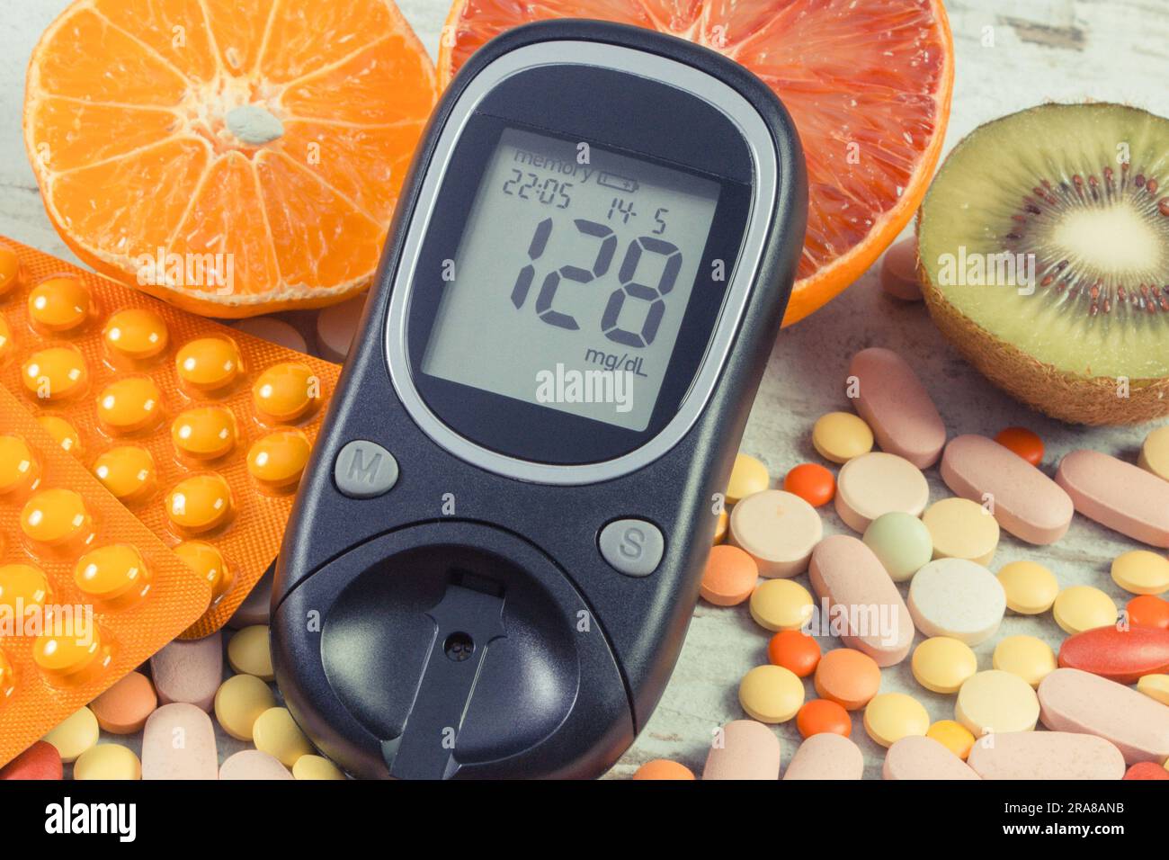 Glucometer with result of sugar level, fresh natural fruits and medical ...