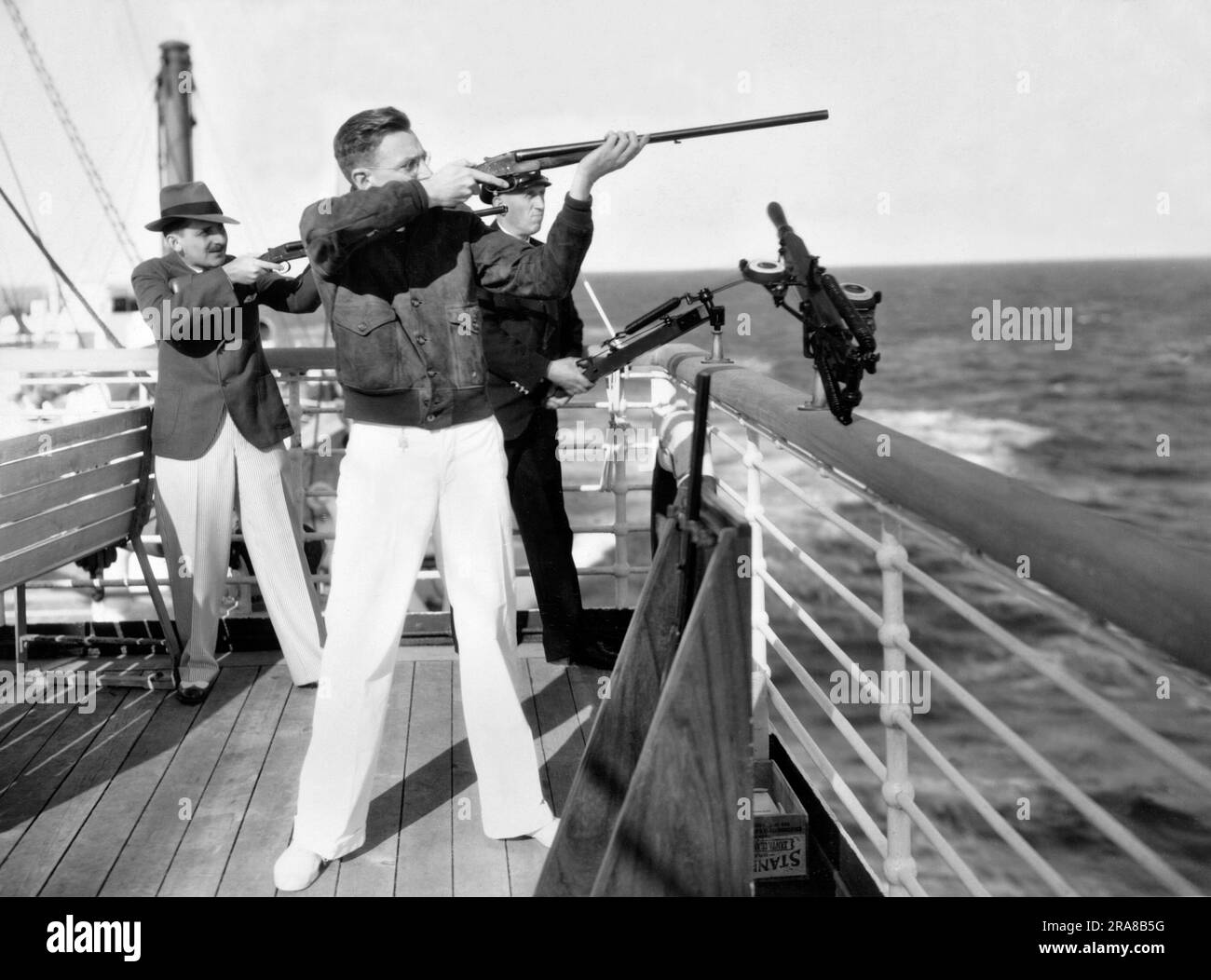 United States: c. 1927 Passengers trap shooting on a passenger ship ...