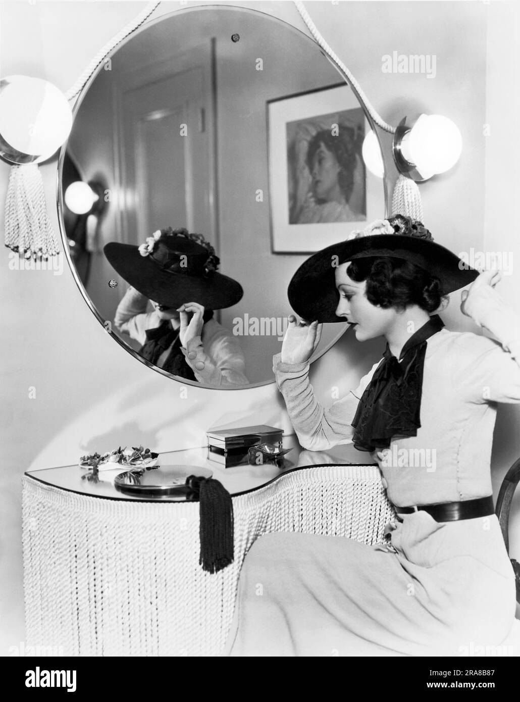 Hollywood, California: c. 1949 A woman in front of her mirror makes ...