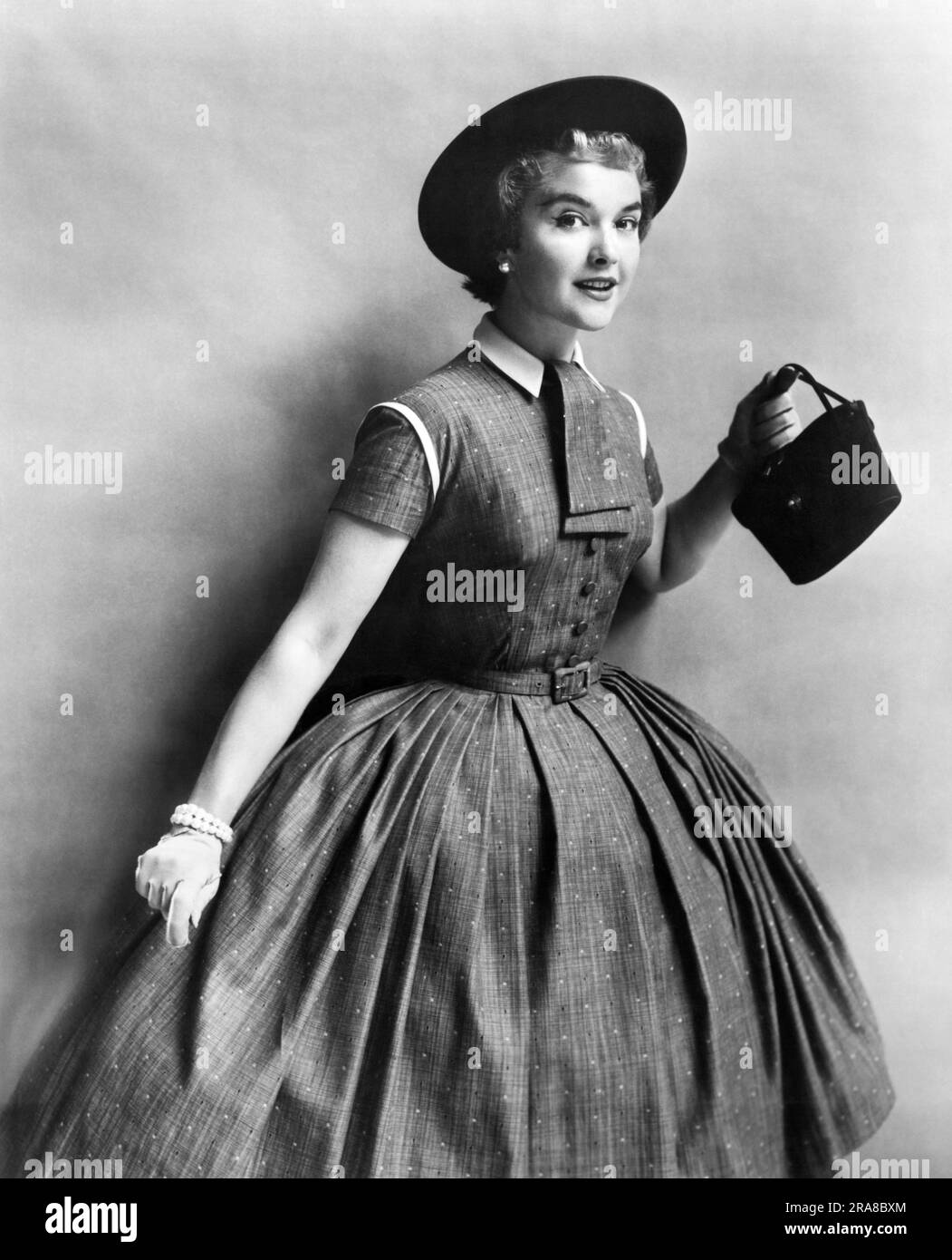 United States: c. 1954 A fashionable young woman modeling a Kay Junior ...