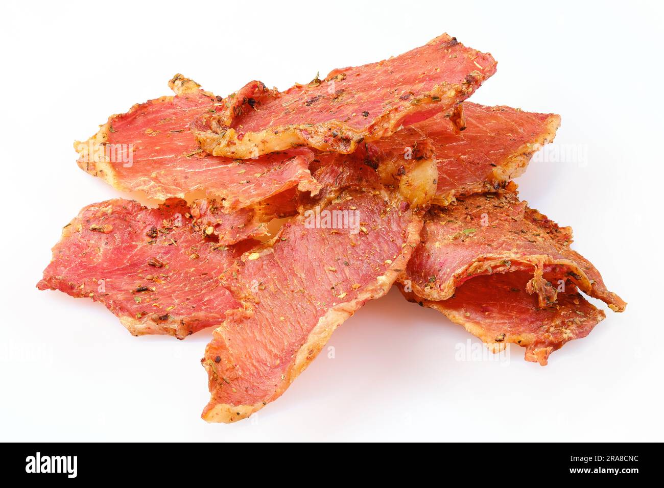 Dried pork jerky slices isolated on white background Stock Photo - Alamy
