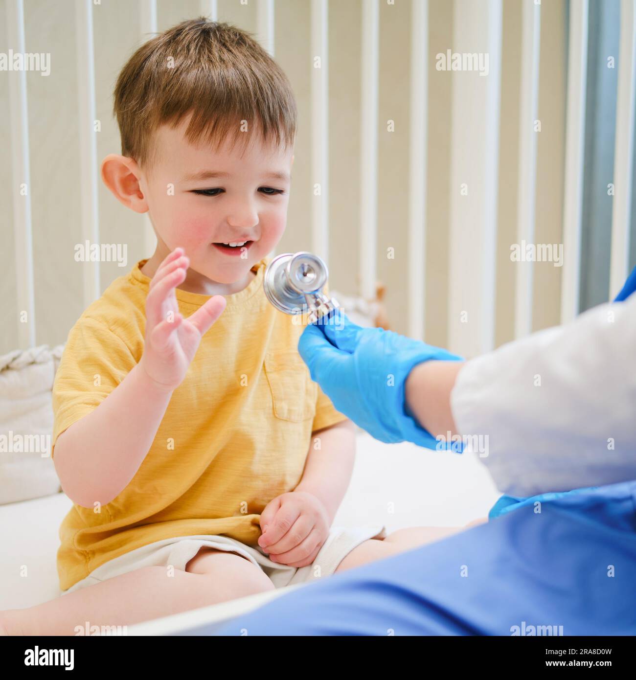 The pediatrician listened to the child's heartbeat with a stethoscope ...