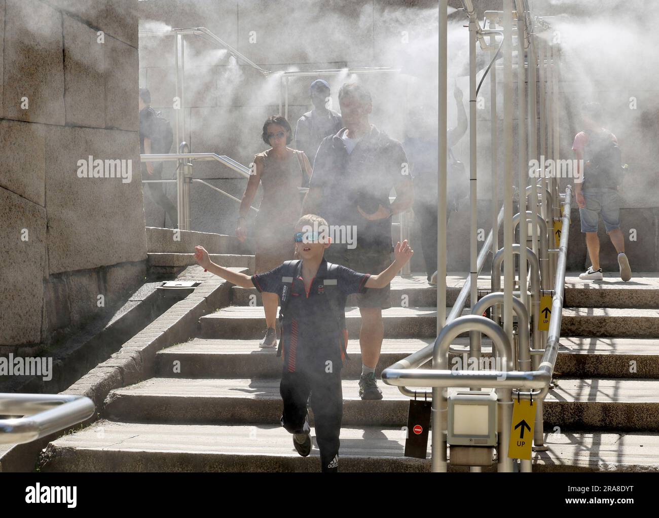 Visitors walk under sprayed mist at Osaka Castle Park in Osaka on July ...