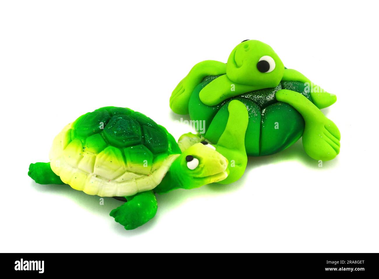 Two hand-made green turtles on a white background Stock Photo - Alamy