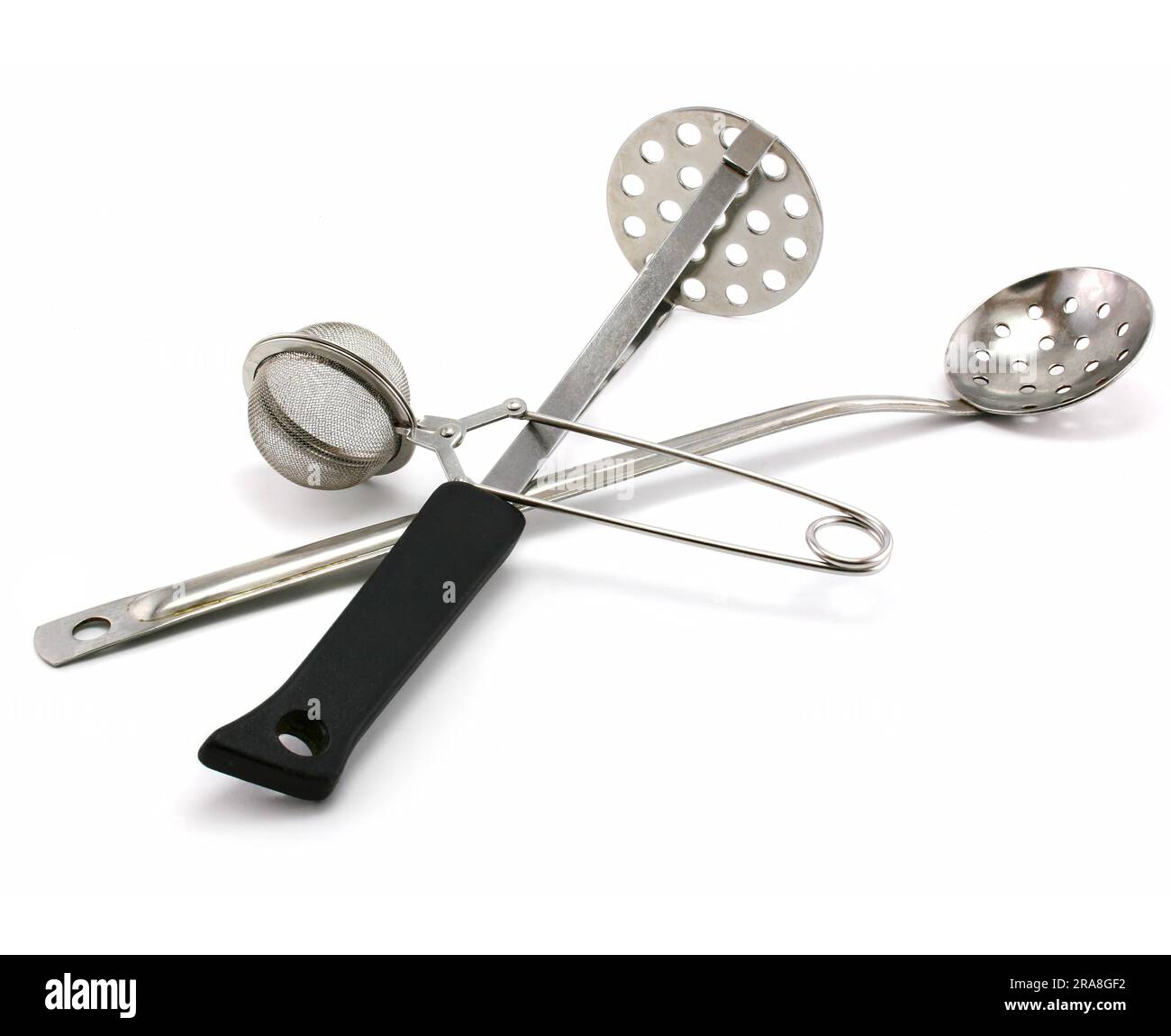 Two perforated spoons and tea strainer isolated on a white background ...