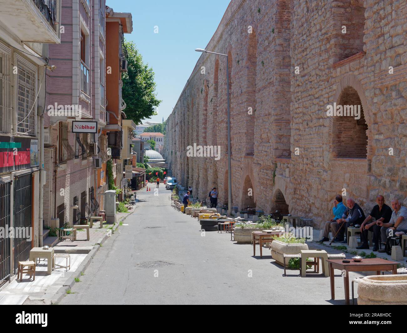 Locals having Turkish Tea on a street beside the Aqueduct of Valens, a ...
