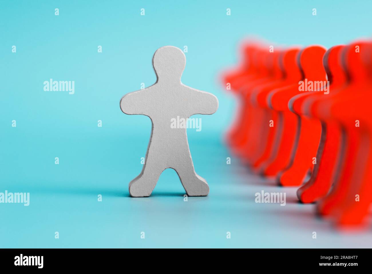 A white human figure stands out from the crowd of red figures Stock ...