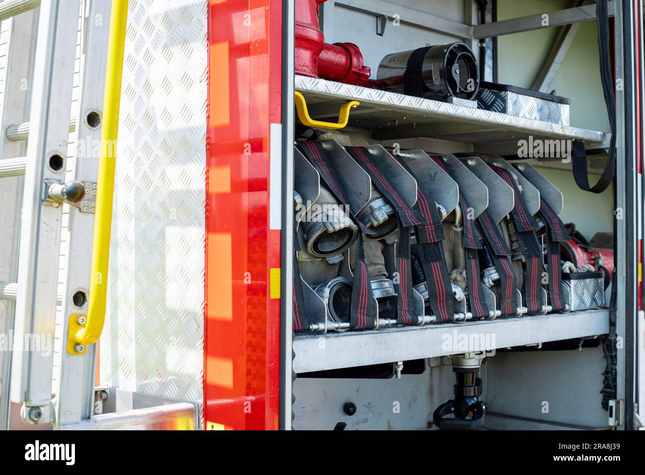 Fire truck equipment. Compartment of the rolled up fire hoses on a fire ...