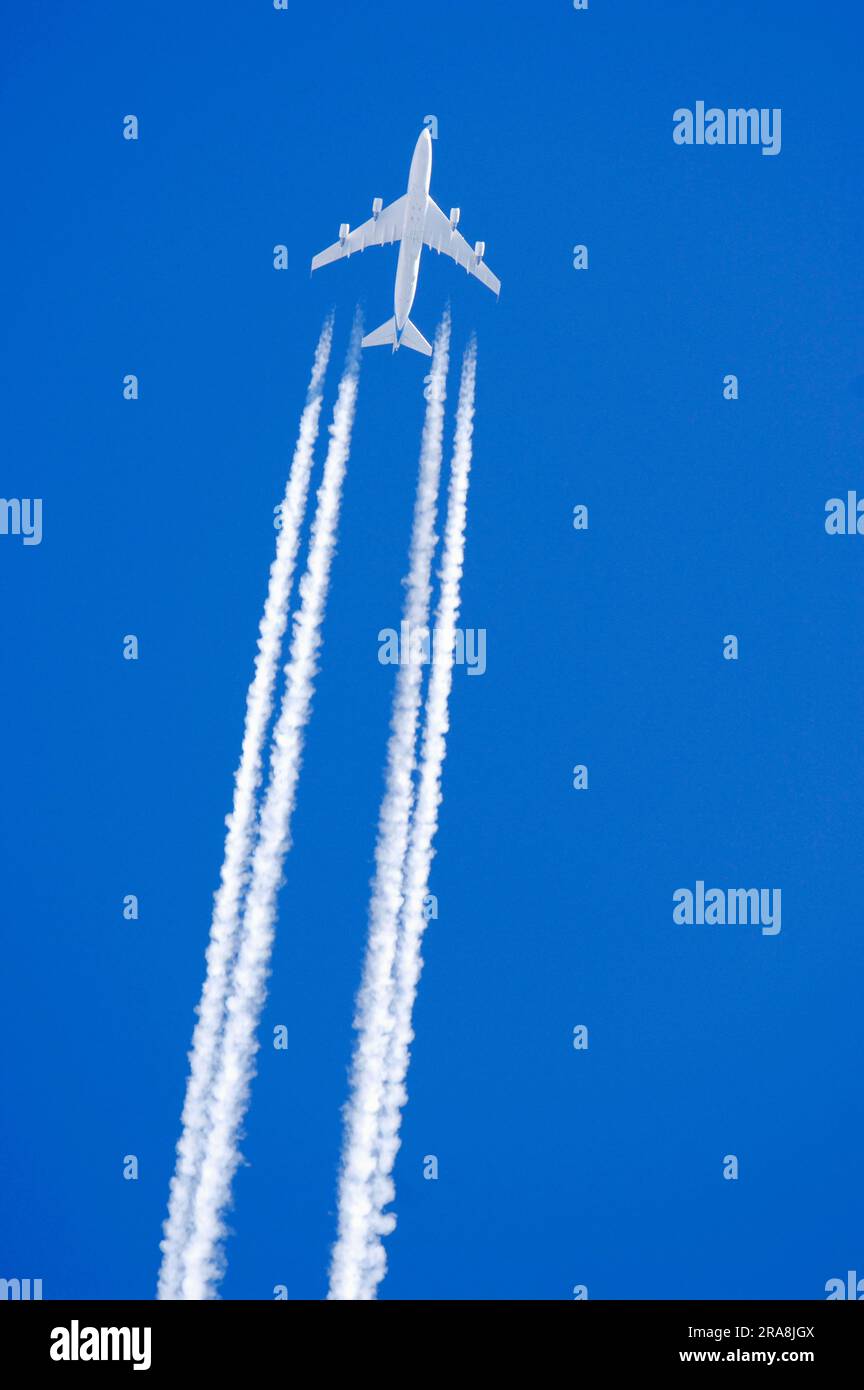 Aircraft with contrails Stock Photo - Alamy