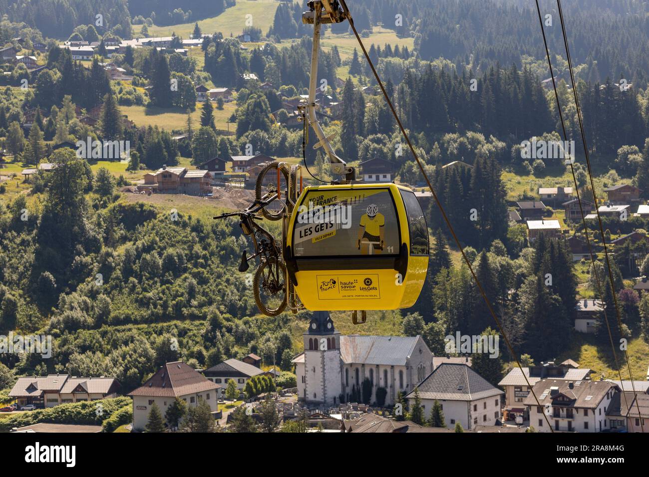 Yellow cable car with Tour de France announcement add and off road ...