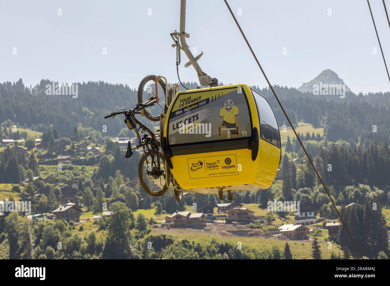 Yellow cable car with Tour de France announcement add and off road ...