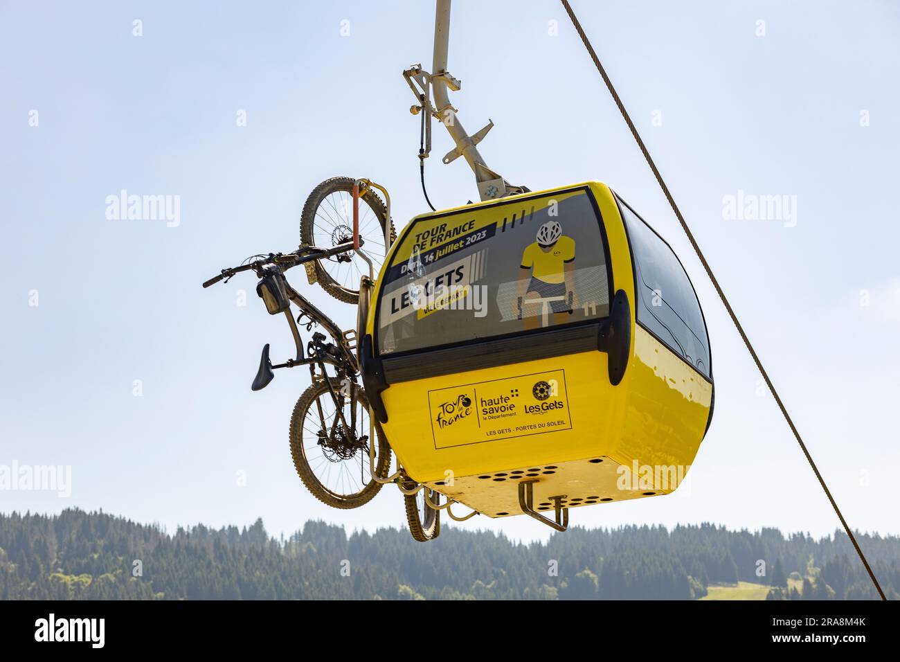 Yellow cable car with Tour de France announcement add and off road ...