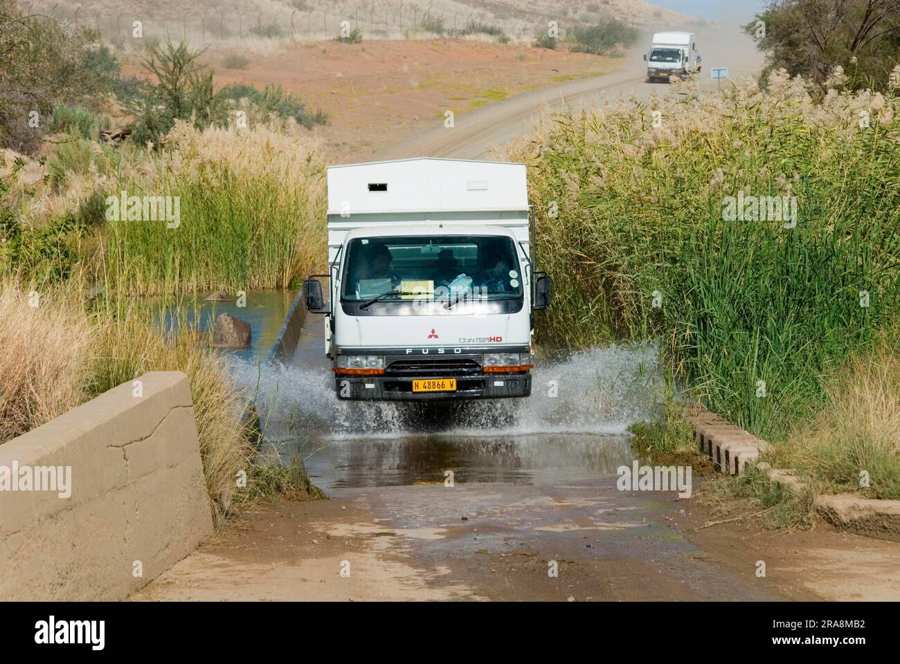 Truck drives through river, Namibia Stock Photo - Alamy