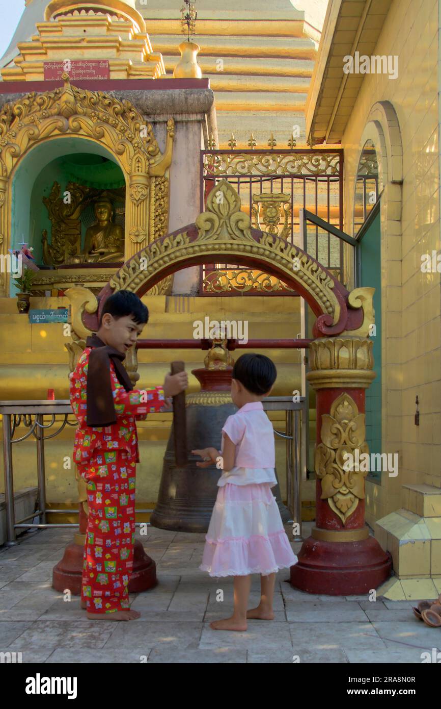 Children striking bell, Sule Pagoda, Yangon, Burma, Myanmar, Yangon ...