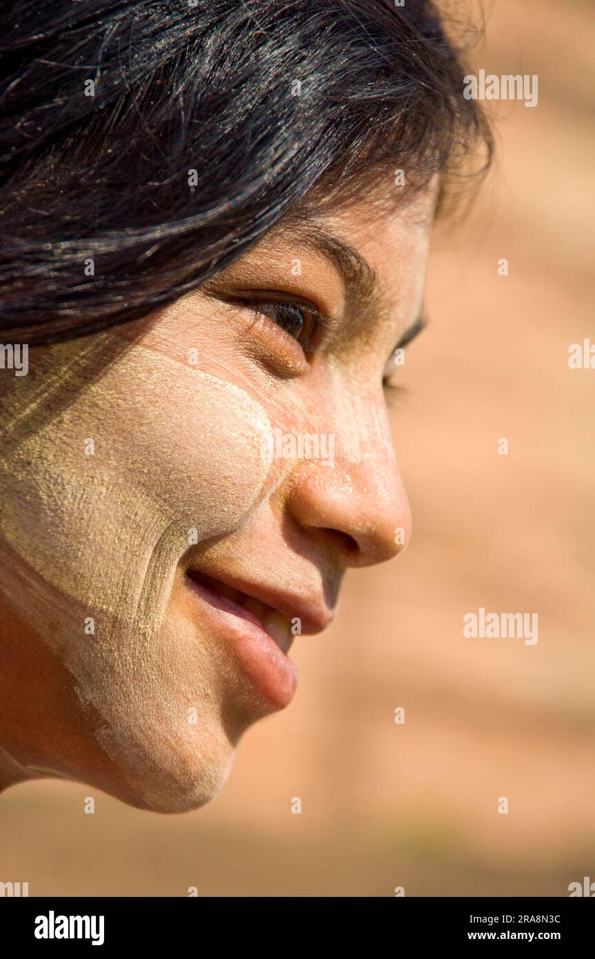 Young Burmese woman with Thanaka paste on her face, Mingun, Burma ...