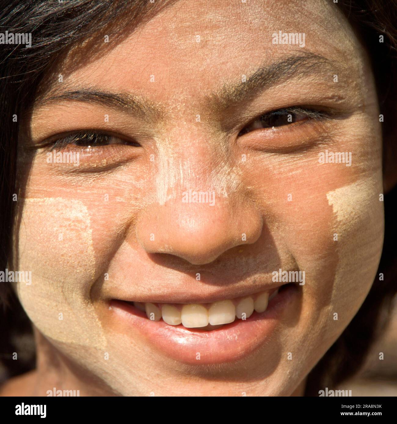 Young Burmese woman with Thanaka paste on her face, Mingun, Burma ...