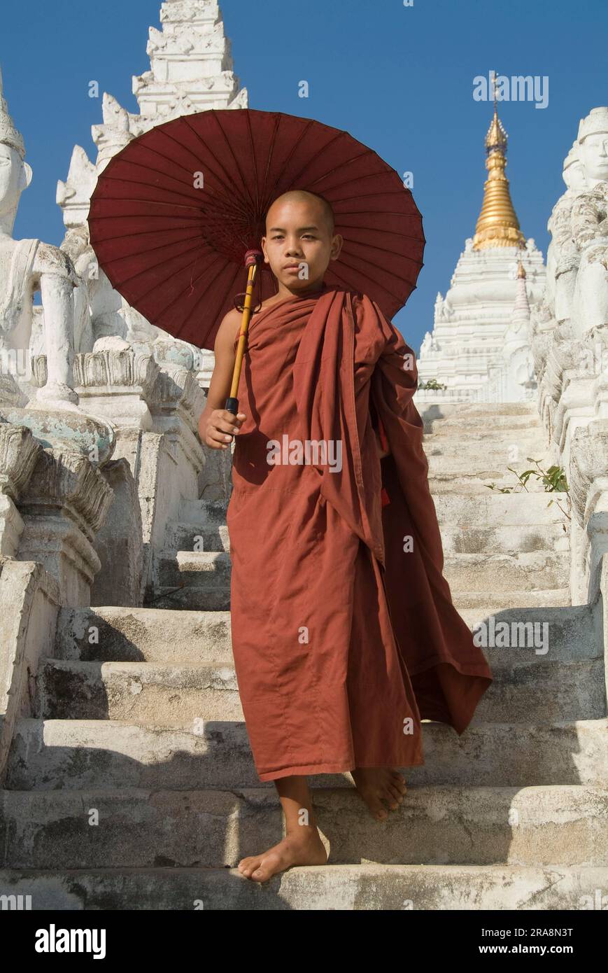 Young Buddhist monk with parasol, Set Taw Ya Pagoda, Mingun, Burma ...