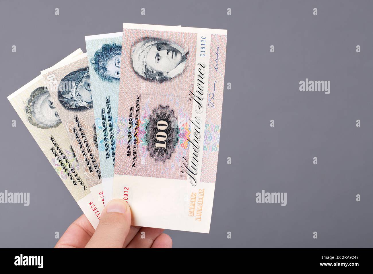 Old Danish money - crowns - in the hand on a gray background Stock ...