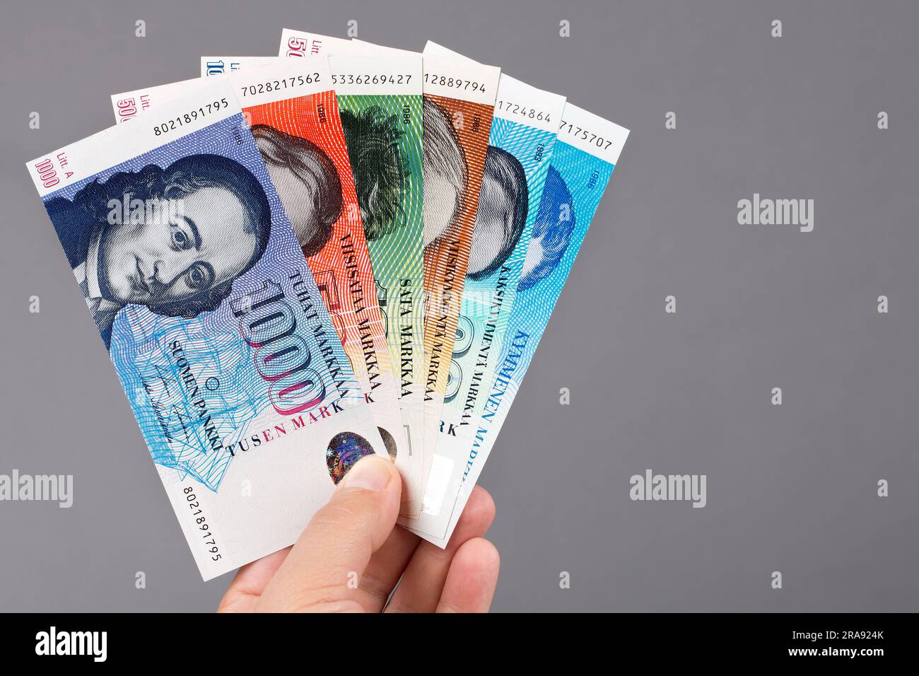 Finnish money - marks - in the hand on a gray background Stock Photo ...