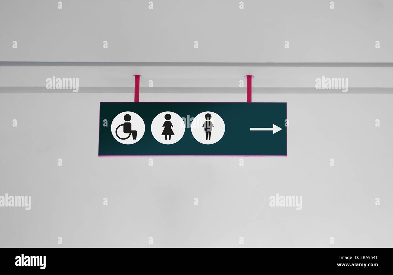 Public toilet sign with symbols and arrow showing direction Stock Photo ...