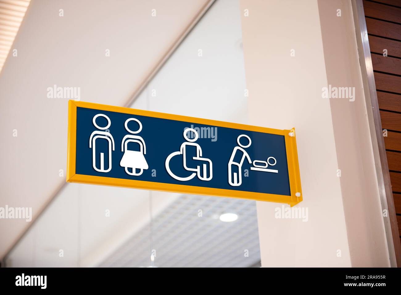 Blue public toilet sign on wall indoors Stock Photo - Alamy