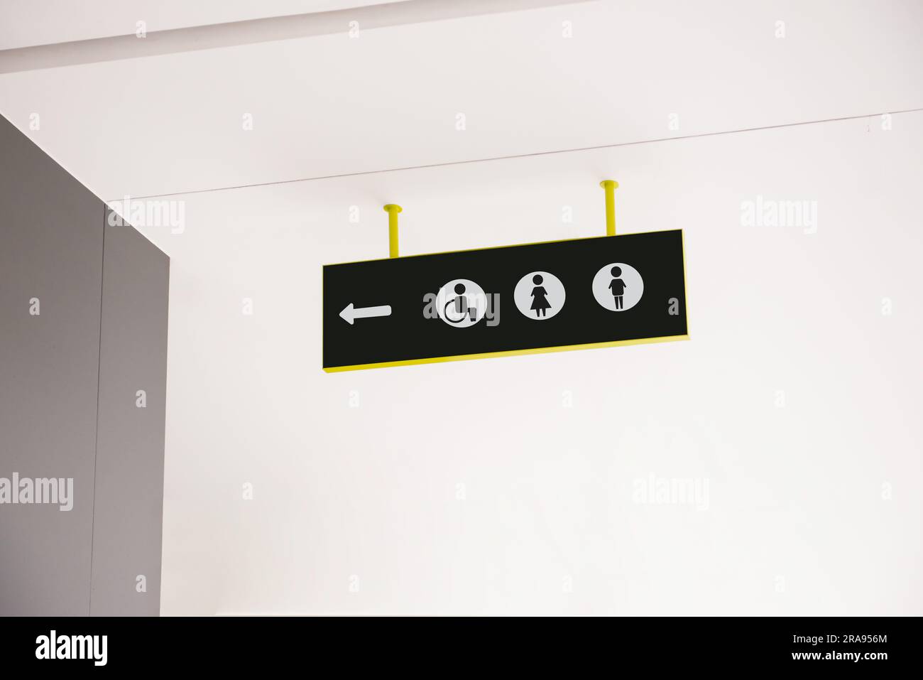 Public toilet sign with symbols and arrow showing direction Stock Photo ...