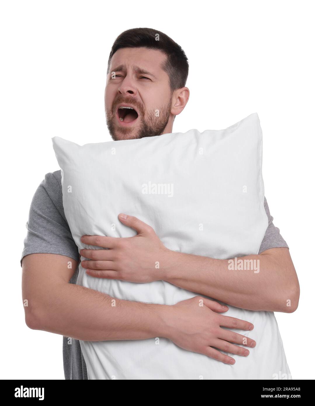 Sleepy man with pillow yawning on white background. Insomnia problem ...