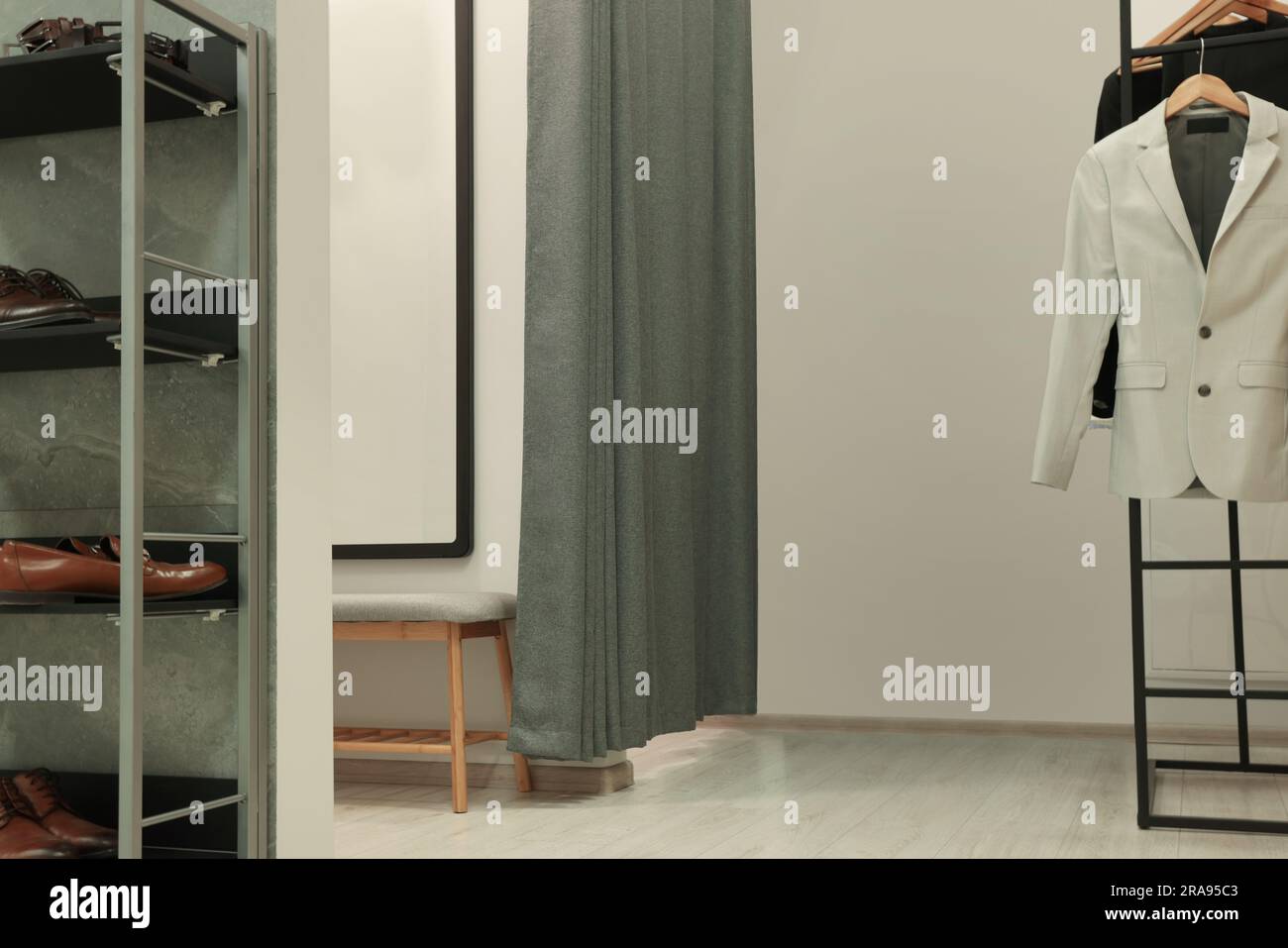 Dressing room with clothing rack in fashion store. Stylish design Stock ...