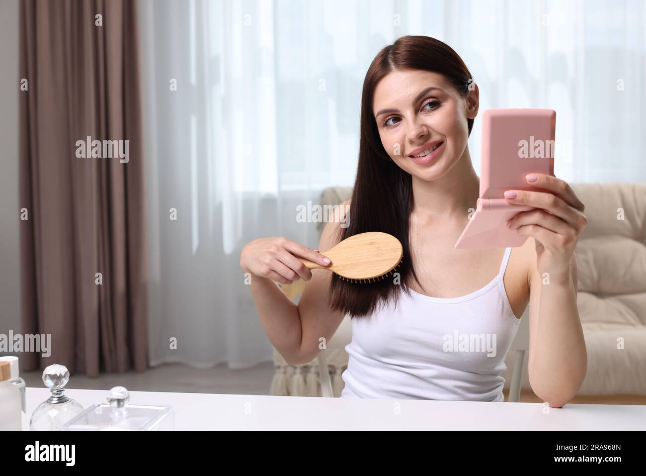 Looking in compact mirror hi-res stock photography and images - Alamy