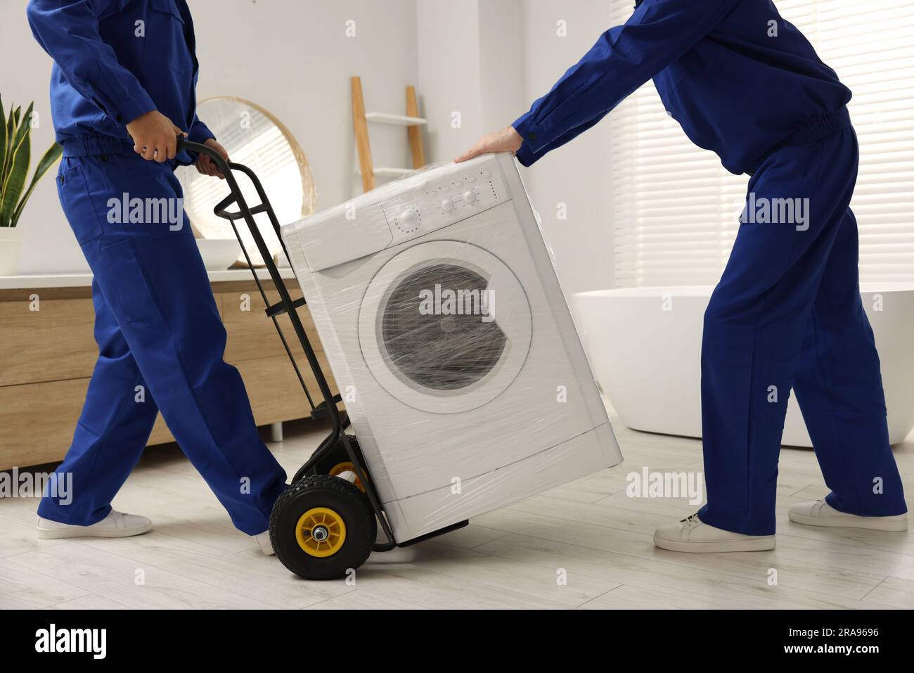 Man carrying washing machine hi-res stock photography and images - Alamy