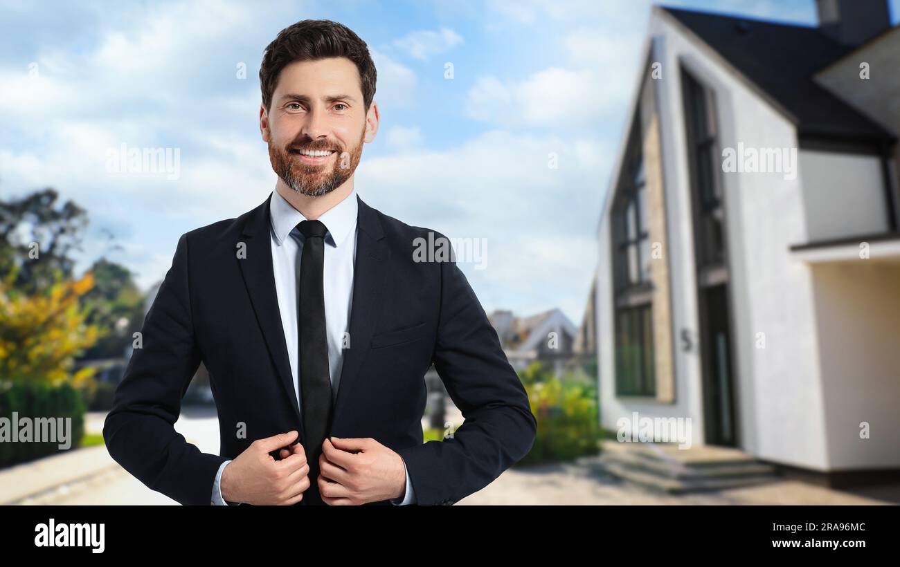 Handsome real estate agent near beautiful house outdoors. Space for ...