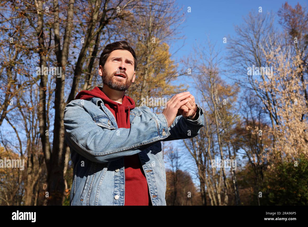 Man checking time on watch outdoors. Being late concept Stock Photo - Alamy