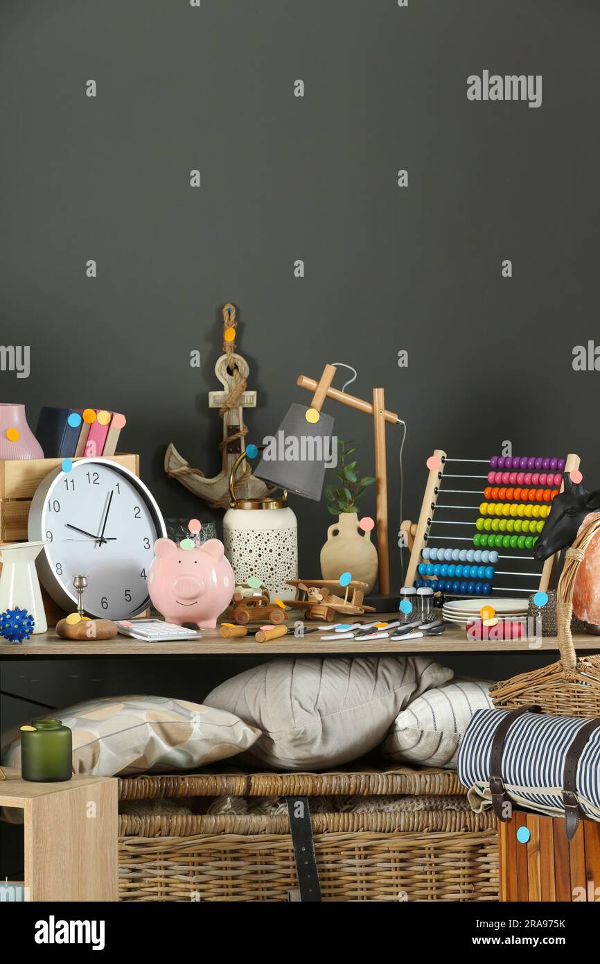 Many different items near grey wall. Garage sale Stock Photo - Alamy