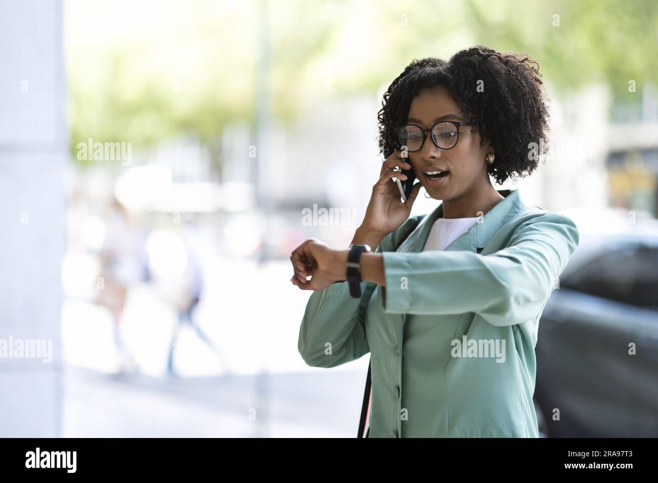 Attractive young black woman getting late for business meeting Stock ...