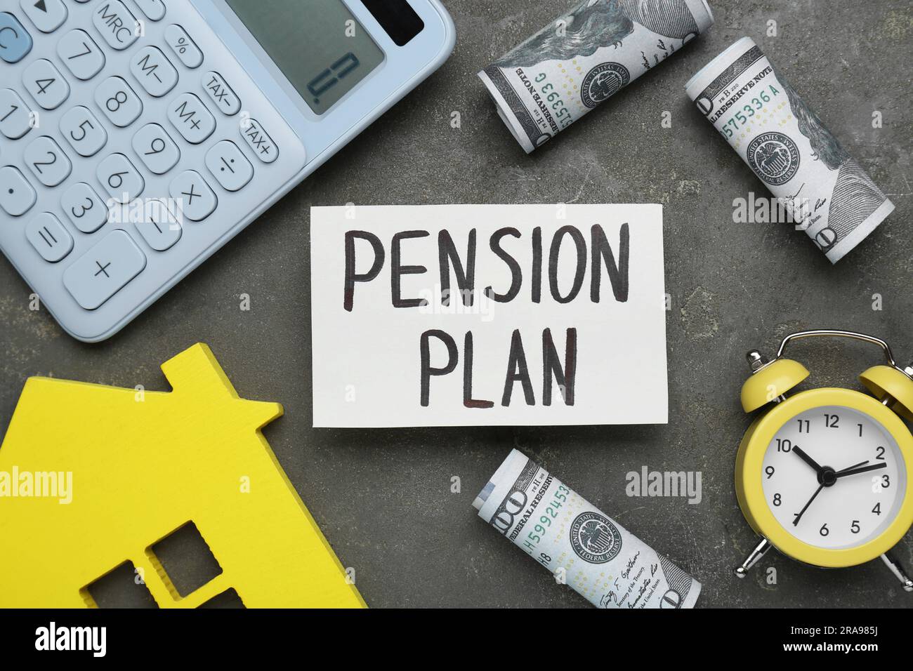 Card with words Pension Plan, calculator, house figure, alarm clock and ...