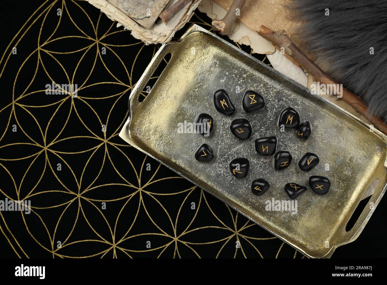 Many black rune stones on divination mat, flat lay. Space for text ...