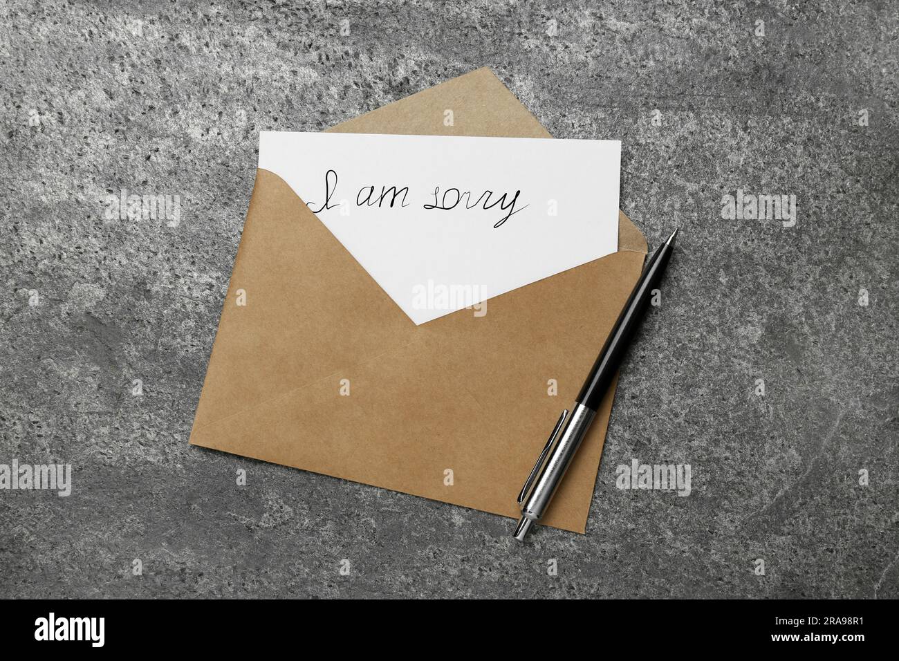 Apology. Card with phrase I Am Sorry, envelope and pen on grey table ...