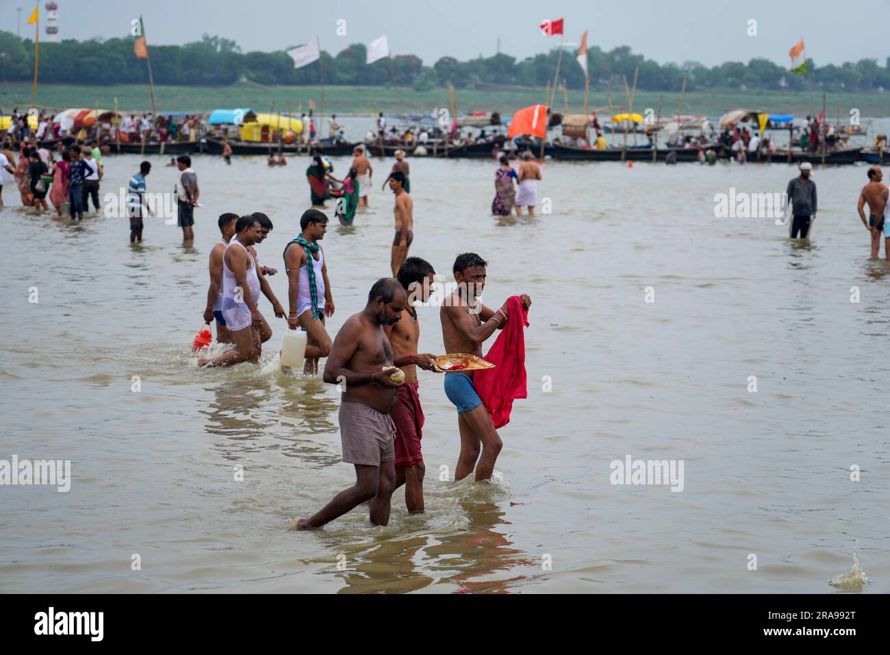 Hindu devotees bath and perform morning rituals at Sangam, the ...