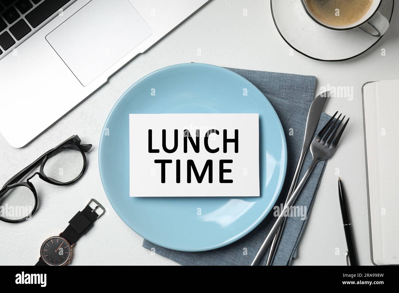 Business lunch. Office desk with plate, cutlery and laptop, flat lay ...