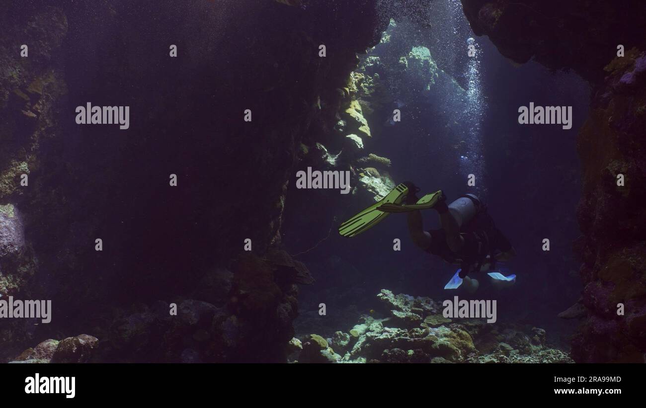 Sunshine penetrate the underwater coral cave and illuminate it ...